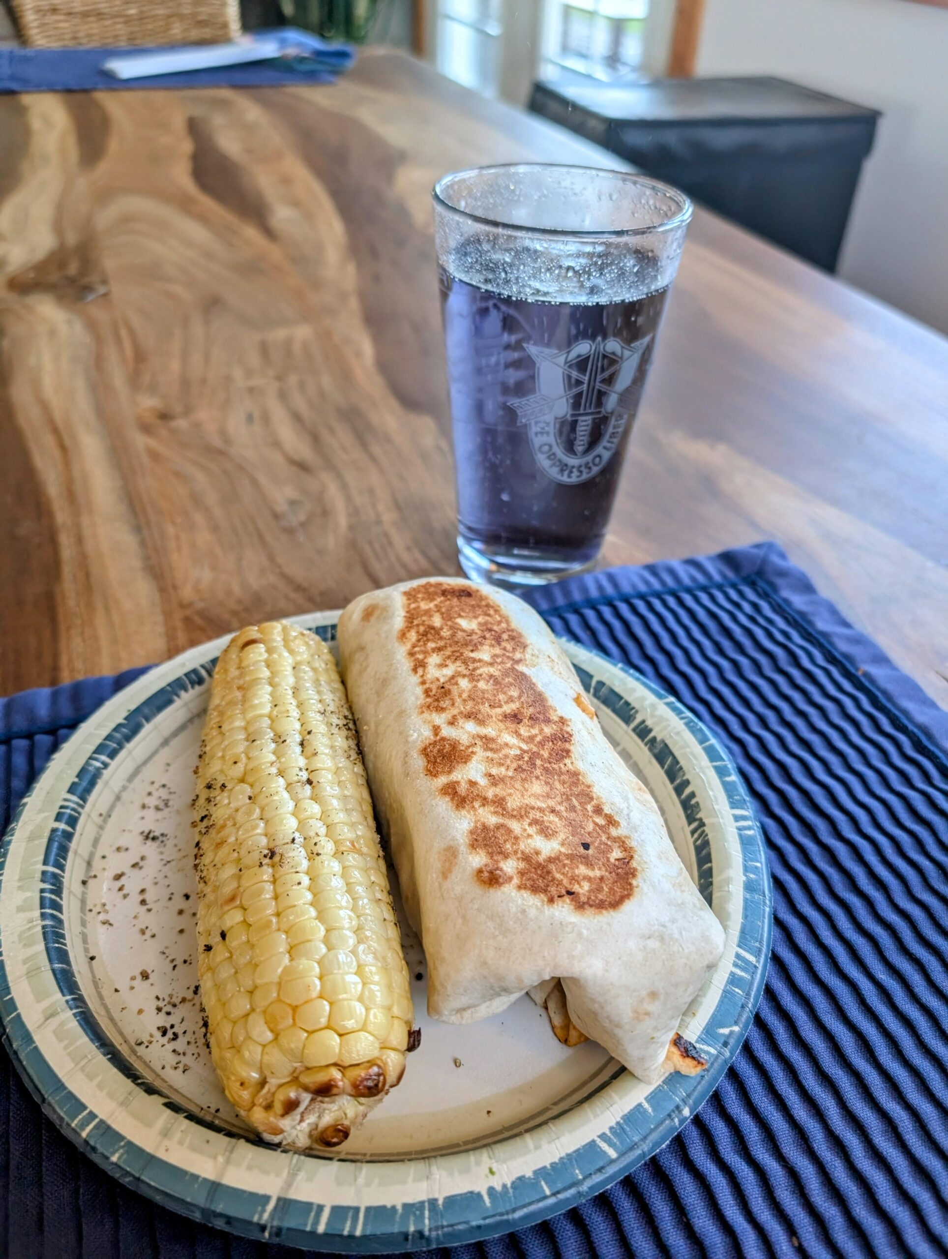 Chicken burrito, corn on the cob, and a glass of purple - foodiedude