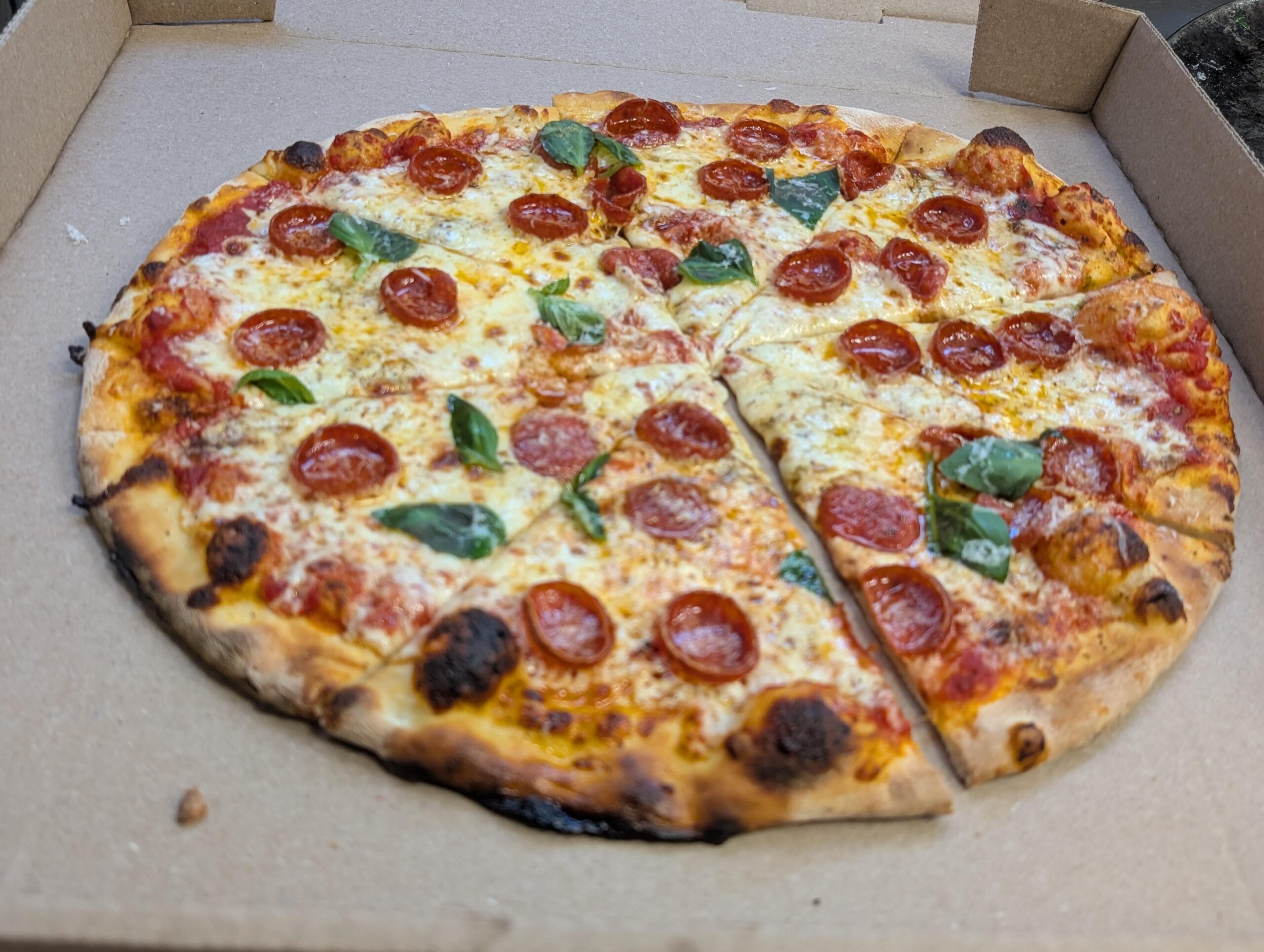 [Pro/chef] Pepperoni and basil pizza out of the brick oven - foodiedude